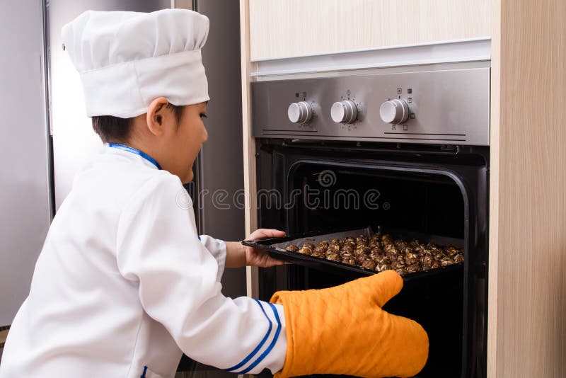 Asian Chinese Boy in White Chef Uniform Baking Cookies Stock Photo ...