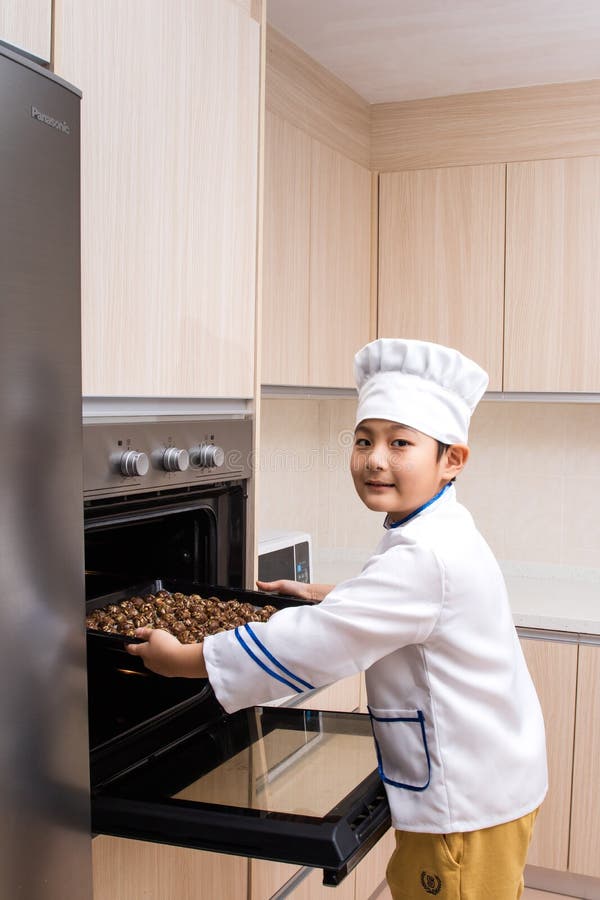 Asian Chinese Boy in White Chef Uniform Baking Cookies Stock Photo ...