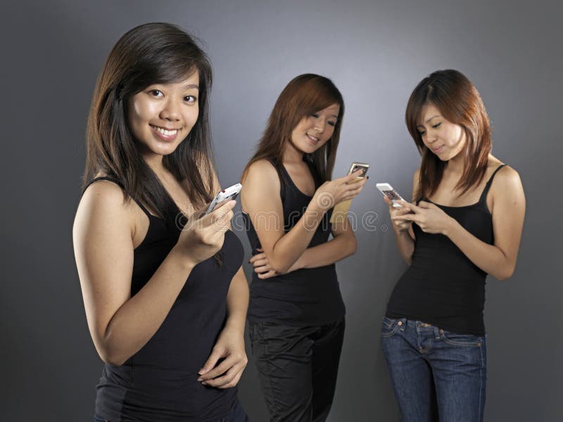 Asian Chinese Girls Using Their Mobile Phones Stock Photo - Image of ...