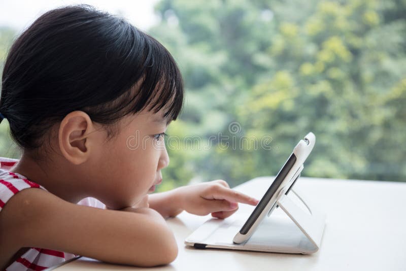 Asian Chinese Little Girl Playing Tablet Computer Stock Photo - Image ...