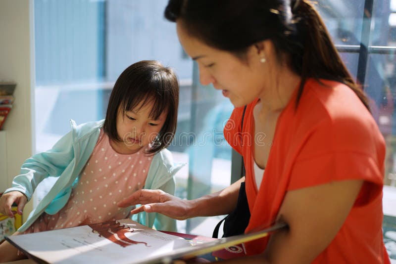 Asian Chinese Mother and Daughter Reading Books in the Library Stock ...