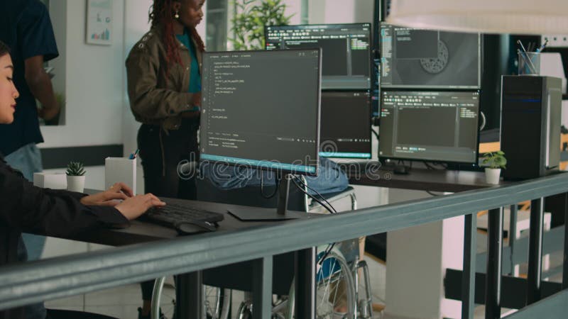 Asian Coder with Physical Disability Working with African American Developer Stock Video - Video ...