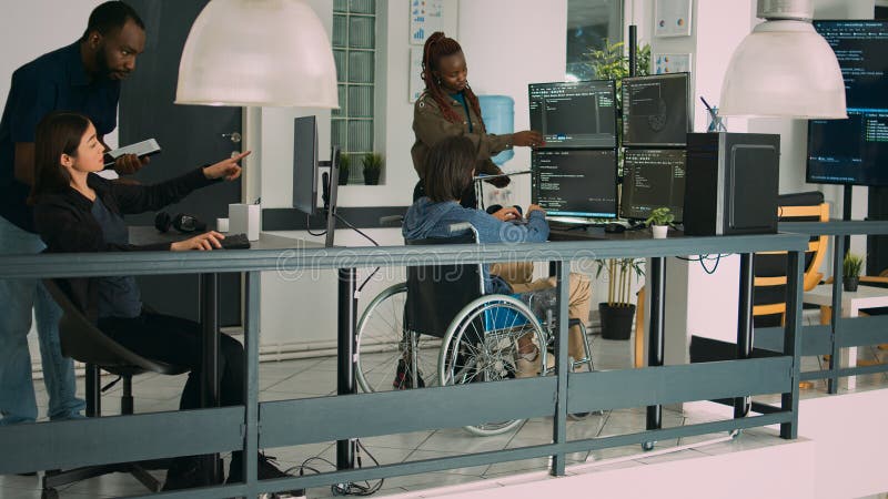 Asian Coder with Physical Disability Working with African American ... Asian Coder with Physical Disability Working with African American ...