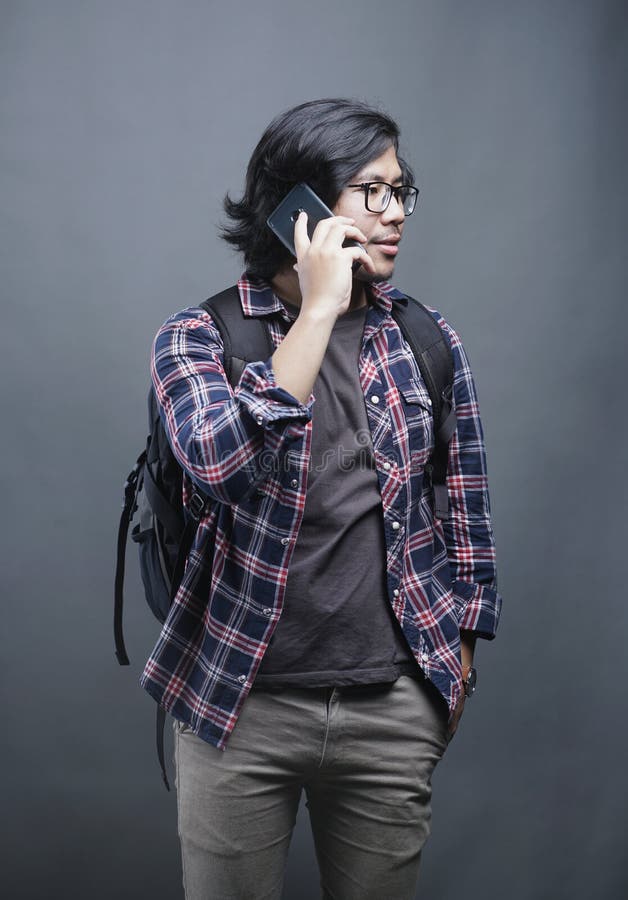 Asian College Student Pick Up Cellphone on Grey Background Stock Image ...