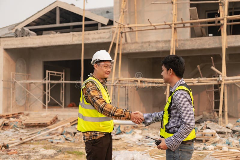 Asian Construction Architects and Engineers Shaking Hands while Working ...