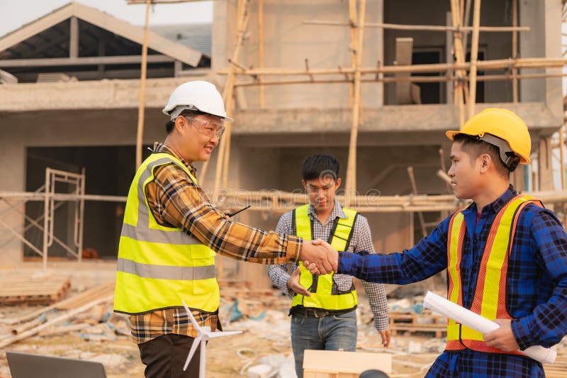 Asian Construction Architects and Engineers Shaking Hands while Working ...