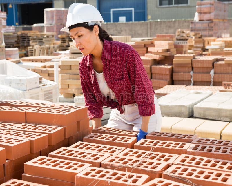 Asian Construction Shop Worker Stacks Bricks on an Open-air Site Stock ...