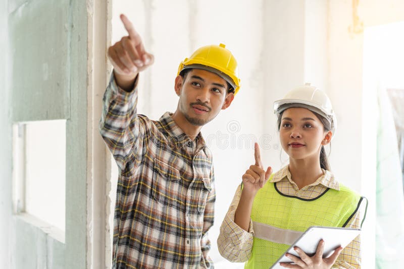 Asian Contractor in Helmet Wearing Vest is Using Walkie Talkie with ...