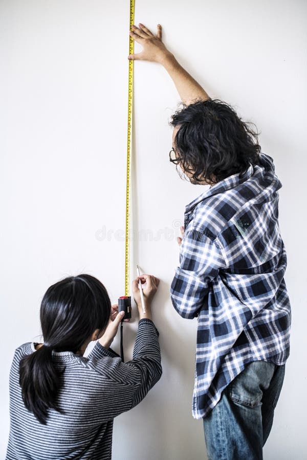 Asian Couple Measuring the Wall Stock Image - Image of boyfriend ...
