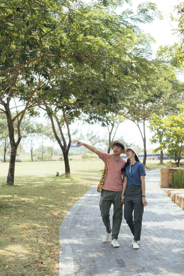 Asian Couple Point Out at Something Stock Image - Image of lover, hold ...
