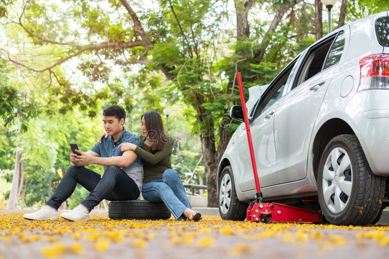 Asian Couple Using Smartphone for Assistance after a Car Breakdown on ...