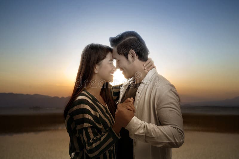 Asian Couples Face To Face And Holding Hands With Each Other Stock
