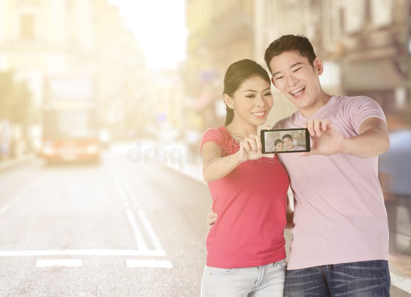 Asian Couples Making a Selfie Using a Camera Phone Stock Image - Image ...