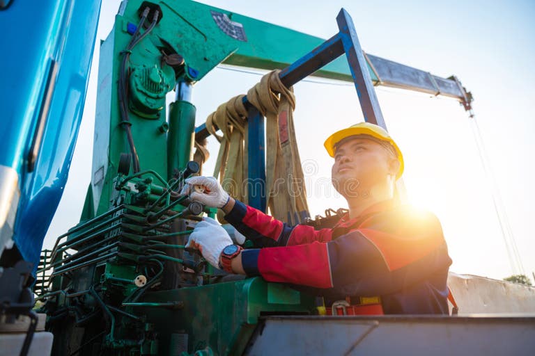 Asian Crane Driver or Worker Operating a Crane at a Construction Site ...