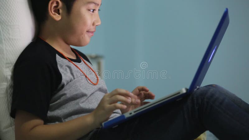 Asian Cute Boy Watching and Smile Games on Laptop Computer. Stock Video ...