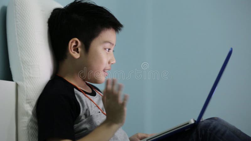 Asian Cute Boy Watching and Talking on Laptop Computer. Stock Footage ...