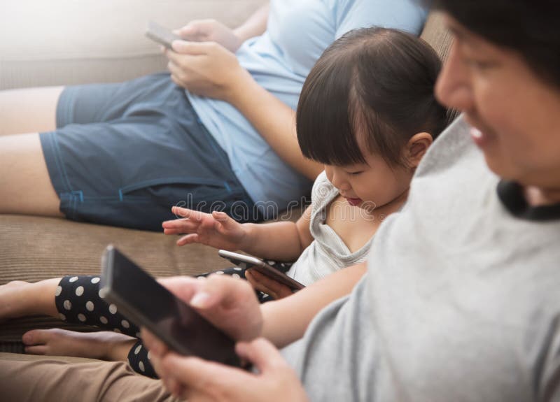 Asian Daughter and Family Using Cell Phone. Stock Image - Image of ...