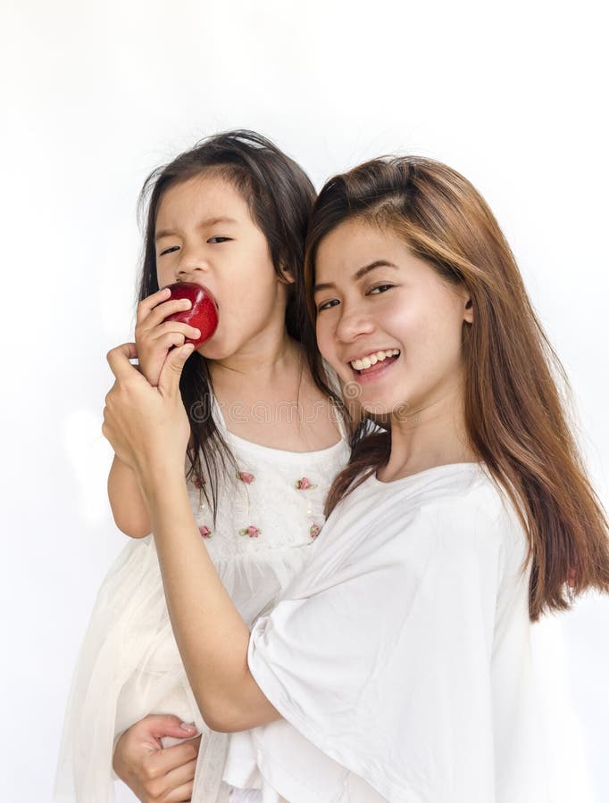 Asian Daughter and Mom Eating Red Apple. Stock Image - Image of ...
