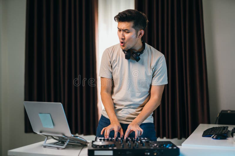 Asian DJ Performing at a Home, High-tech Mixer Console Stock ...