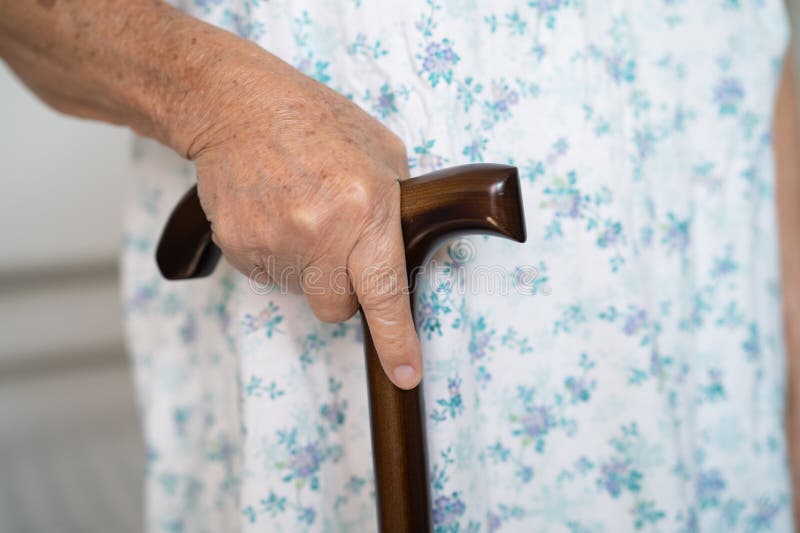 Asian Elderly Disability Woman Holding Waling Stick Wood Cane Round