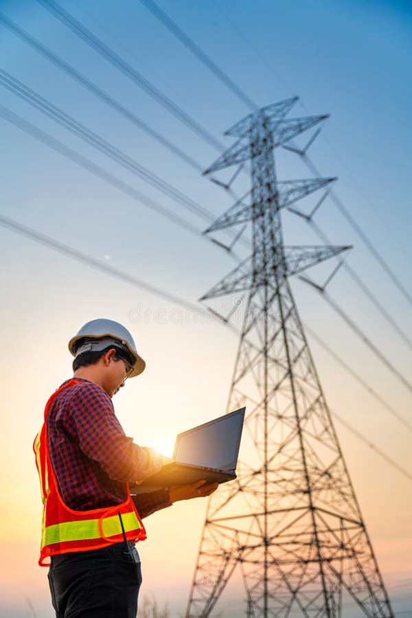Asian Electrical Engineer Checking Position Using Notebook Computer at ...