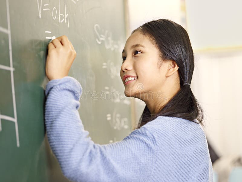 Asian Elementary School Student Solving a Math Problem Stock Image ...
