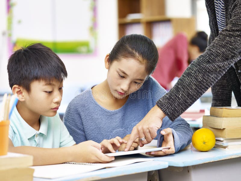 Asian Elementary Schoolchildren Using Digital Tablet Stock Photo ...