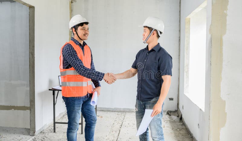 Asian Engineer and Architect Handshake at Construction Property Site ...