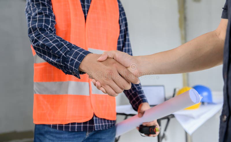 Asian Engineer and Architect Handshake at Construction Property Site ...