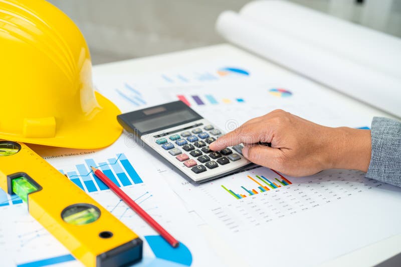 Asian Engineer with Architectural House Plan Project Blueprint, Graph ...