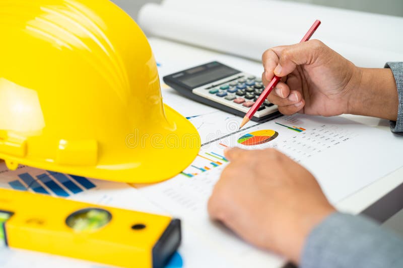 Asian Engineer with Architectural House Plan Project Blueprint, Graph ...