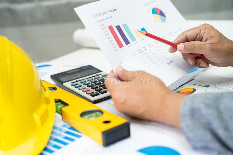 Asian Engineer with Architectural House Plan Project Blueprint, Graph ...