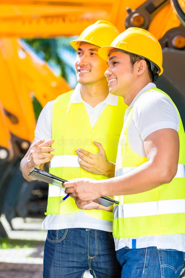 Asian Engineer Discussing Plans on Construction Site Stock Photo ...