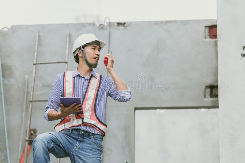 Asian Engineer Leading Construction Project at Construction Site, Professional Builder on Duty ...