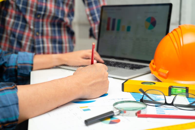 Asian Engineer with Architectural House Plan Project Blueprint, Graph ...