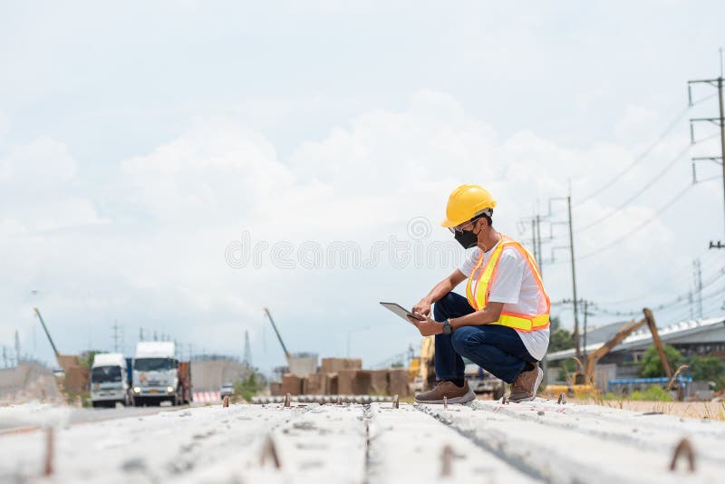 Asian Engineer Wearing Hard Hat and Safety Vest is Checking the ...