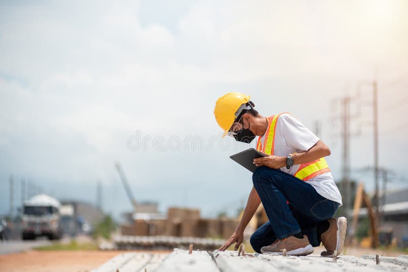 Asian Engineer Wearing Hard Hat and Safety Vest Sitting and Looking the ...