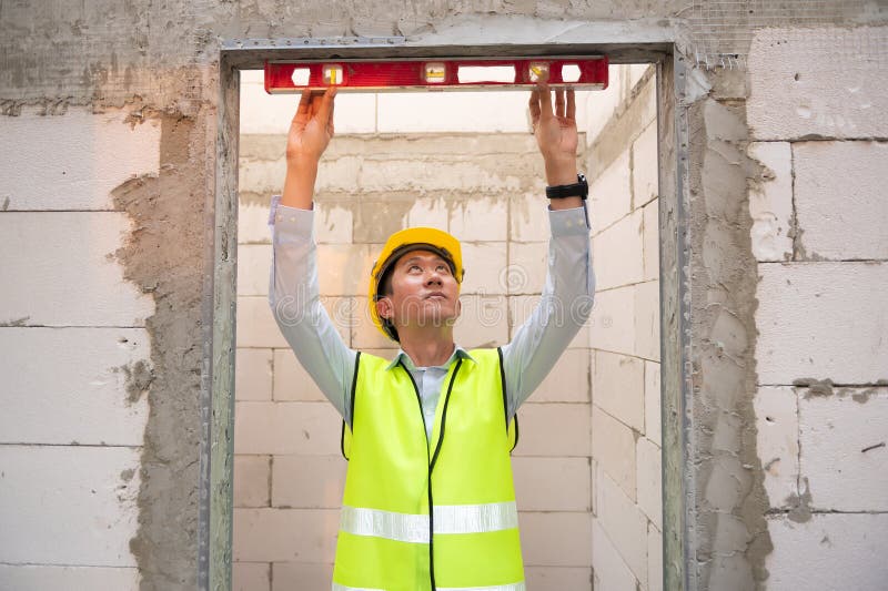 Asian Engineering Man Wearing Safety Helmet Checking Construction Site ...