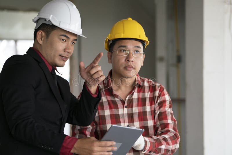 Asian Engineers Were Consulted Together and Plan in Construction Site ...
