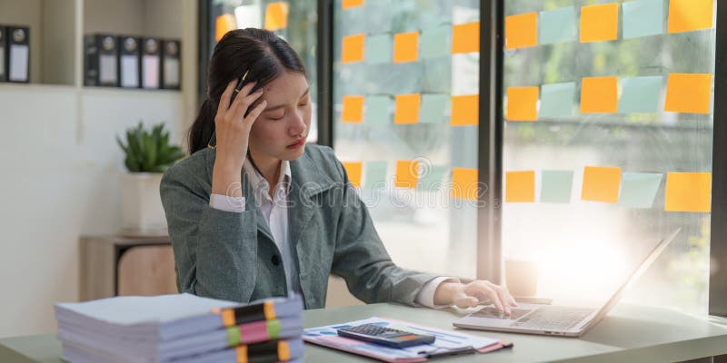 Asian Entrepreneur Making Business Plan while Working on Laptop with ...