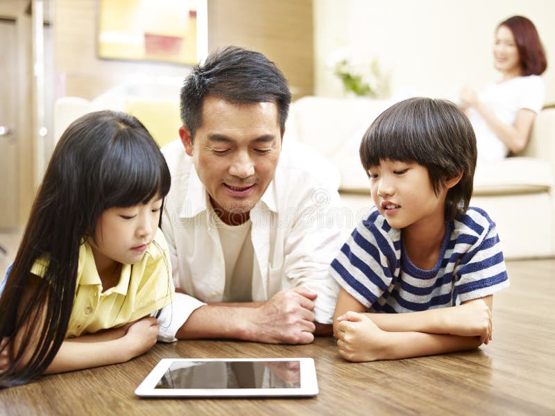 Asian Mother and Two Children Using Digital Tablet Together Stock Photo ...