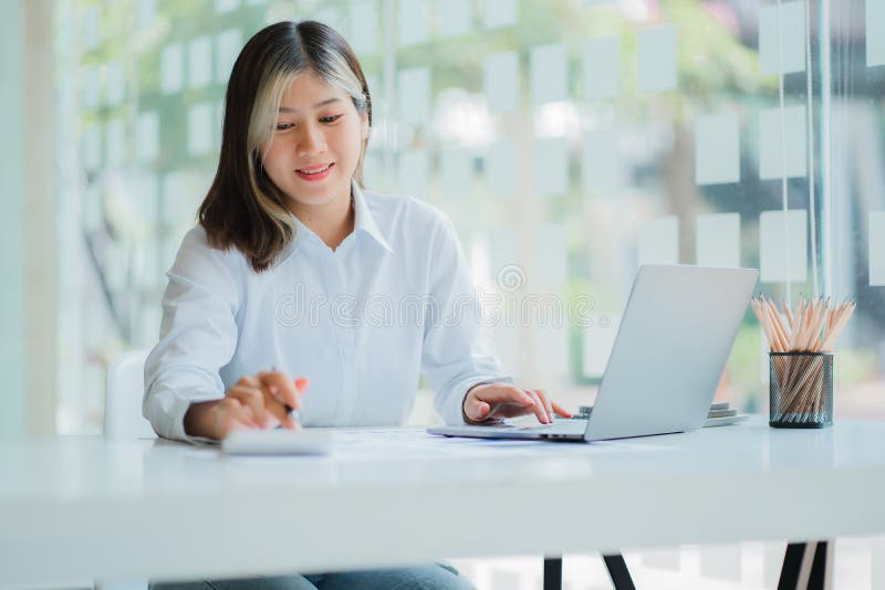 Asian Female Accountant Doing Calculations Analyzing Reports Pointing ...
