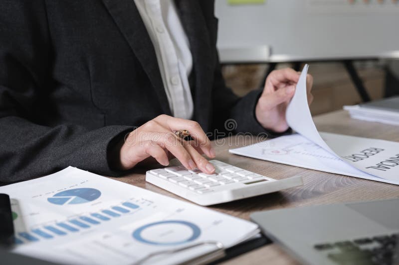 Asian Female Accountant Working on Calculations on Table in Office ...