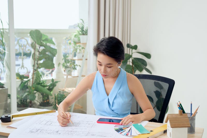 Asian Female Architect Working at Home.she Looking Blueprints Stock ...