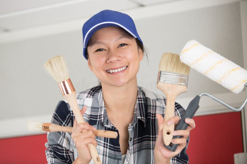 Asian Female Decorator Holding Paintbrushes and Roller Stock Image ...