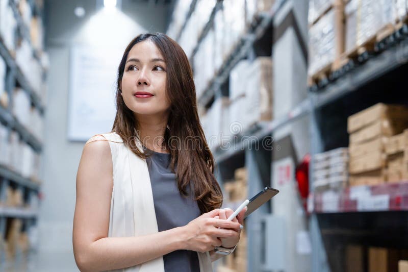 Asian Female Manager Stocking Cardboard Boxes on Shelves in Warehouse ...
