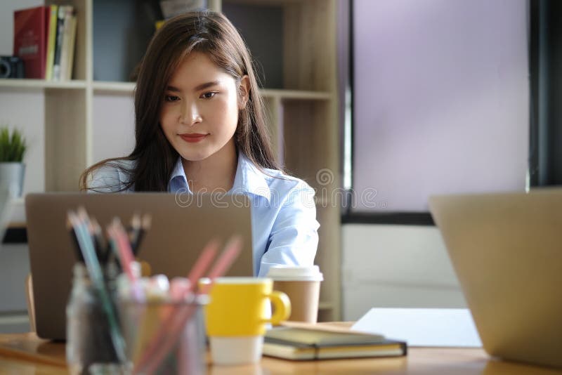 Asian Female Office Worker Using Laptop Computer at Comfortable ...