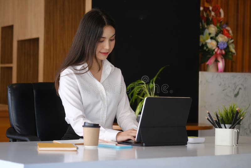 Female Office Worker Working with Computer Tablet Wile Sitting in ...