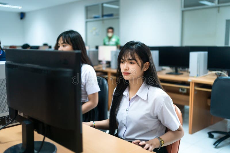 Asian Female Student is Working on a Laptop Computer in a Study Room ...