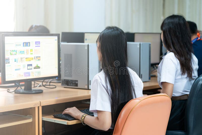 Asian Female Students are Sitting Side by Side in Front of a Computer ...
